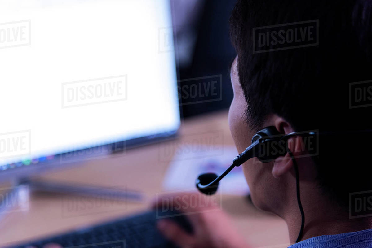 Young Asian call center business people working late night shift for ...