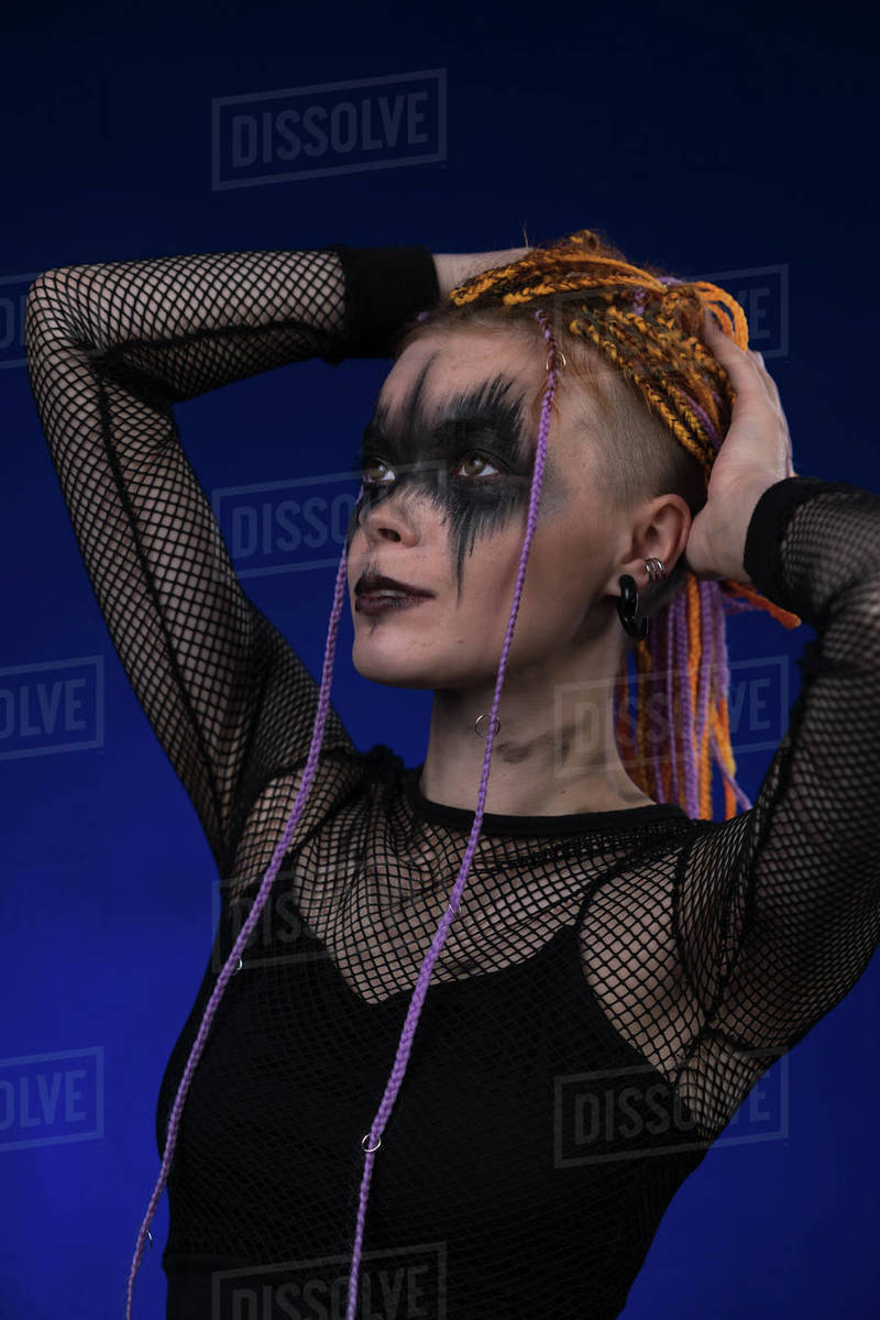 Cinematic portrait of young woman with orange color braids hairdo and ...
