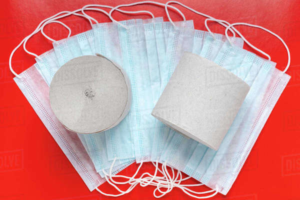 Top view of rolls toilet paper on background antiviral face masks and ...