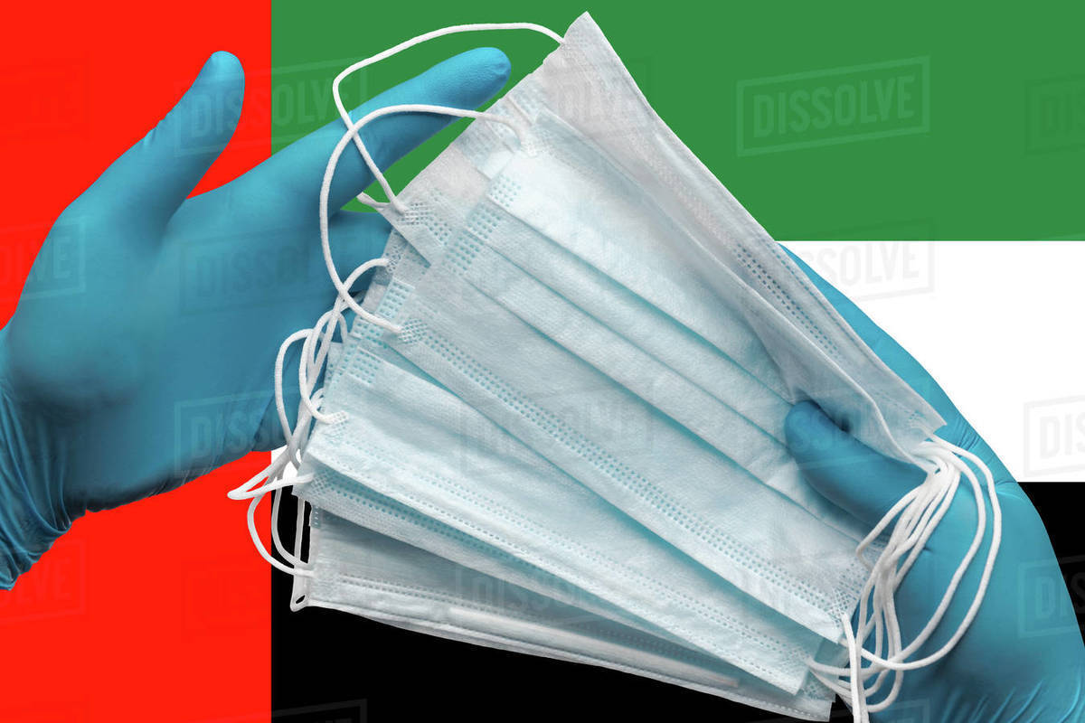 Medic holding respiratory face mask in hands in blue gloves on ...