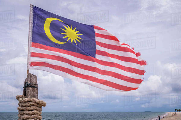 Malaysian flag attached on pole waving on beach in Langkawi island on a ...