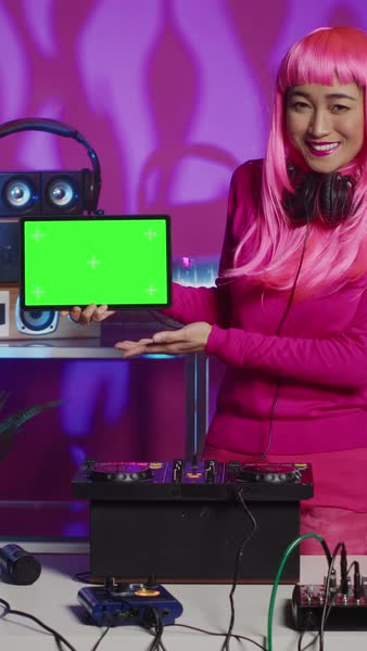 Vertical video: Dj with pink hair holding green screen chroma key ...