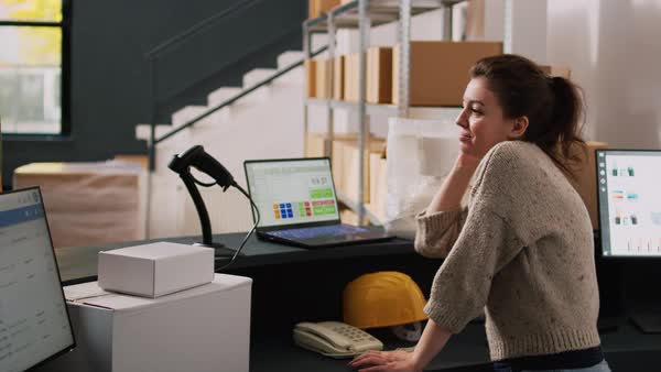 Worker carrying boxes to check barcodes and merchandise stock in ...
