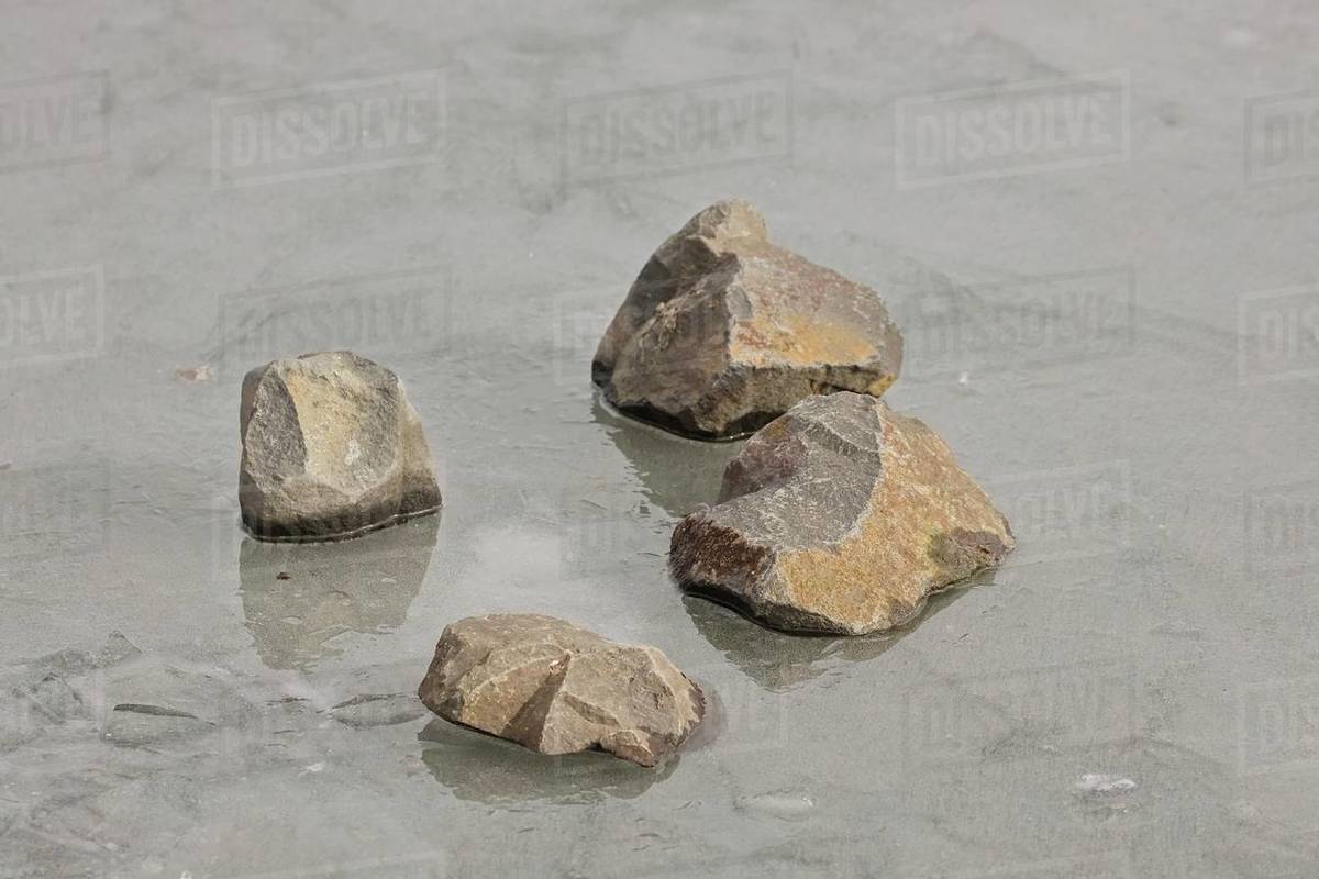 An abstract photo of rocks laying on melting ice in Hauser, Idaho ...