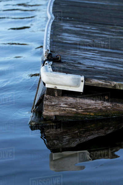 An old wooden deck partly submerged in the water of Coeur d'Alene Lake ...