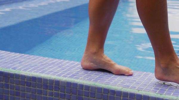 Close-up of feet walking by pool and dipping toe in water. - 4K Royalty ...