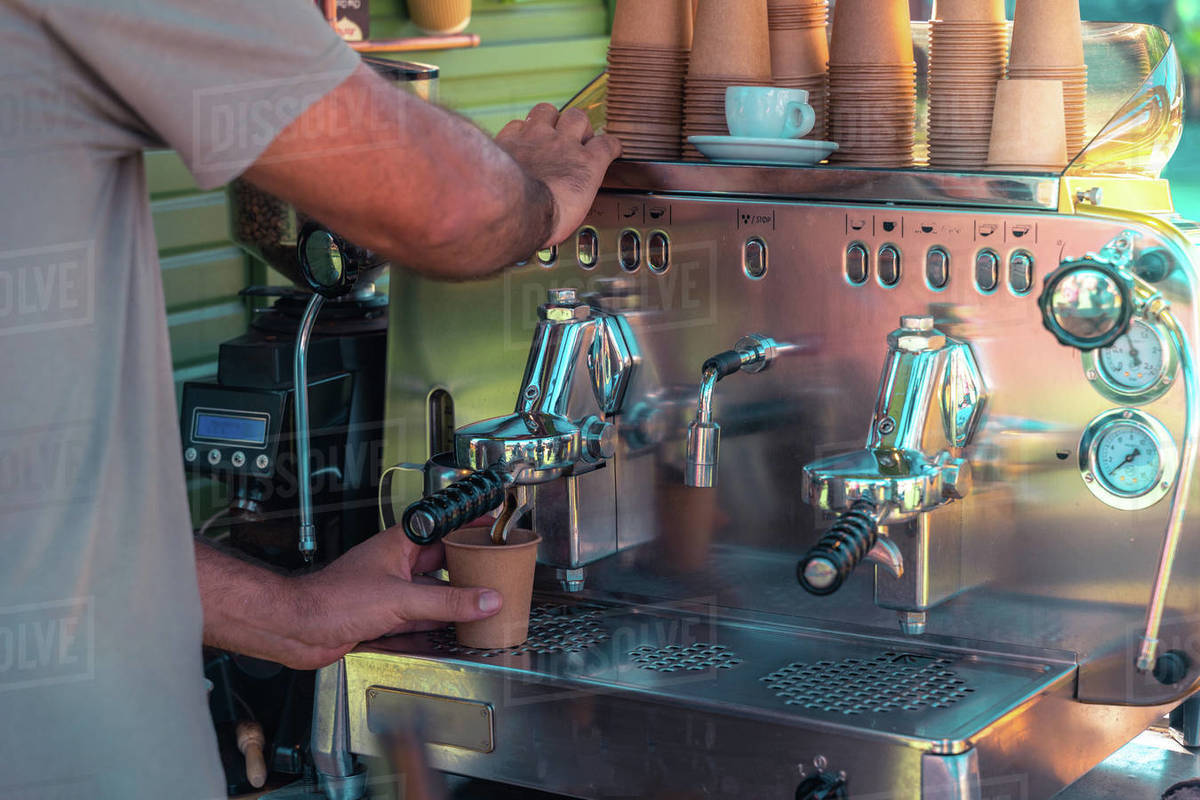 Barista making coffee with retro style coffee machine and Filling ...