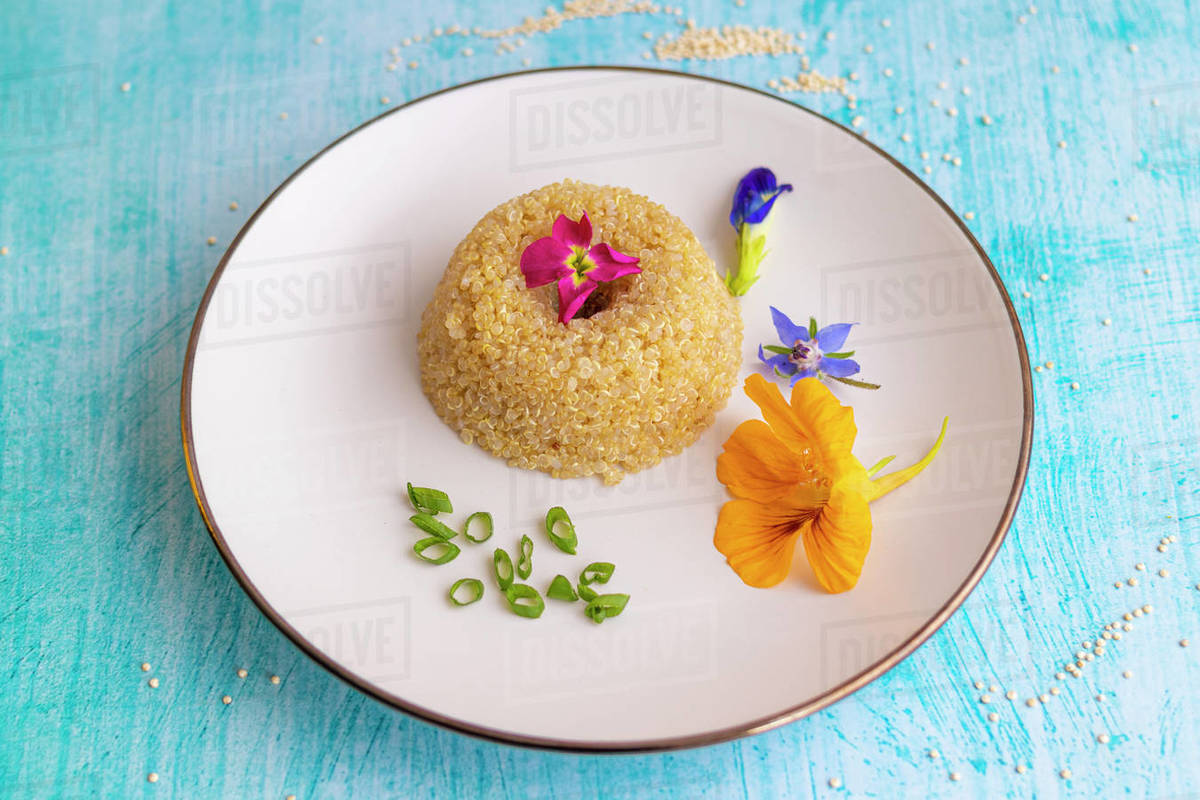 Quinoa plate presentation decorated with edible flowers - Royalty-free ...