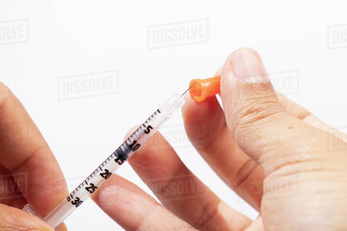 Hand holding an insulin syringe before being used - Royalty-free Stock ...