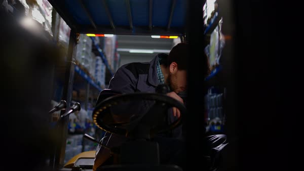 Stressed sad Caucasian warehouse loader taking off hard hat leaving ...