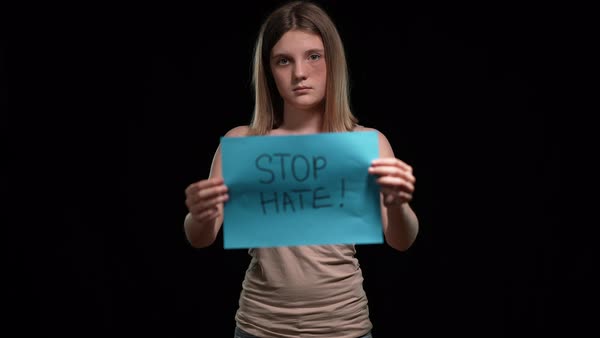 Portrait of Caucasian sad teenage girl with bruise on face showing Stop ...