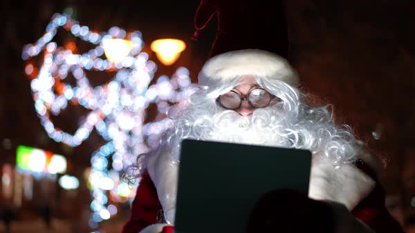 Portrait of Santa using online map application standing with digital ...