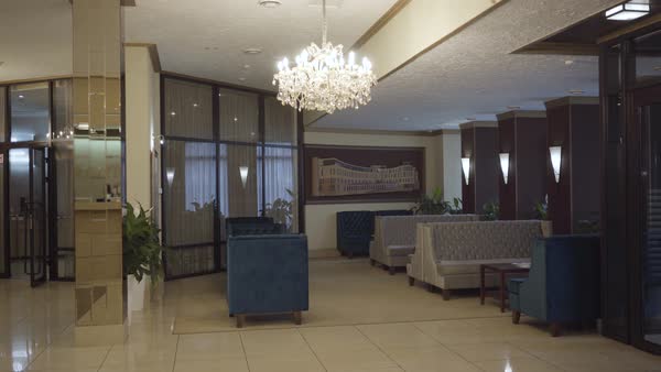 Wide shot of luxurious lounge zone in high-class hotel lobby ...