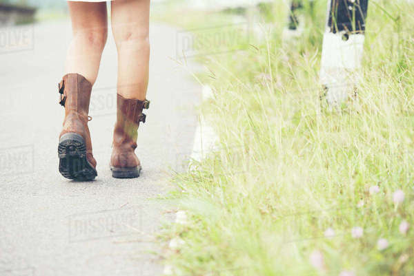Beautiful Woman Wear Brown Boots Walking on the road. - Royalty-free ...