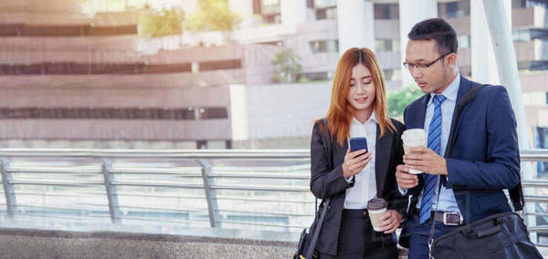 Banner Businessman Businesswoman drinking coffee in town using ...