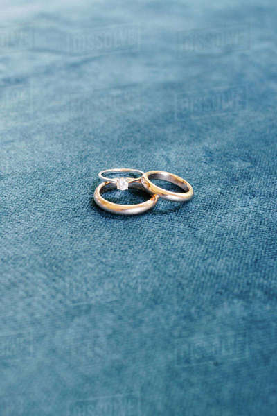 Diamond rings and wedding rings. Blue background. Wedding accessories ...