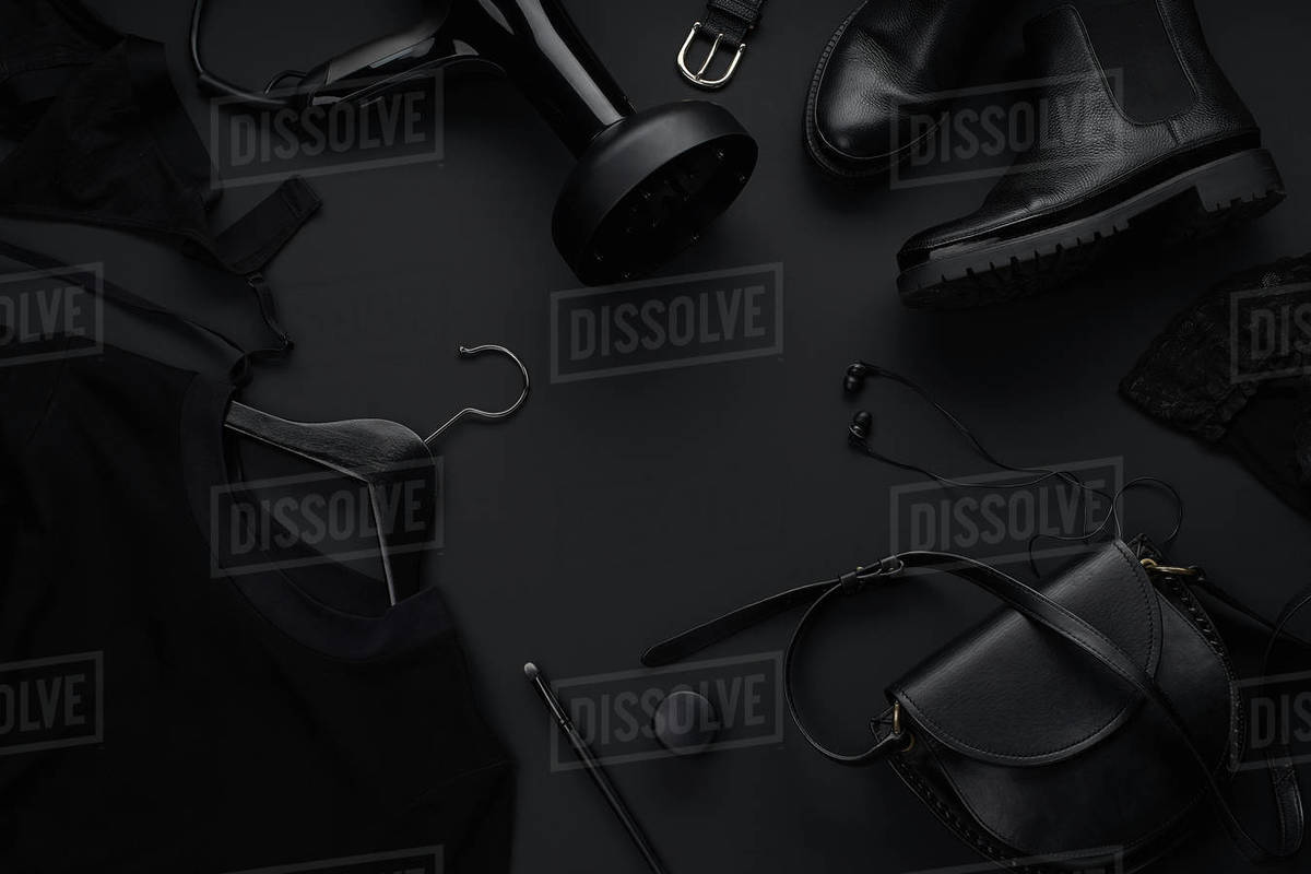 Black monochromatic flatlay on black background. Clothes, accessories ...