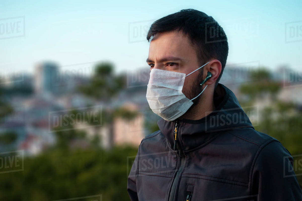 Isolated young man wearing mask to protect himself from the corona ...
