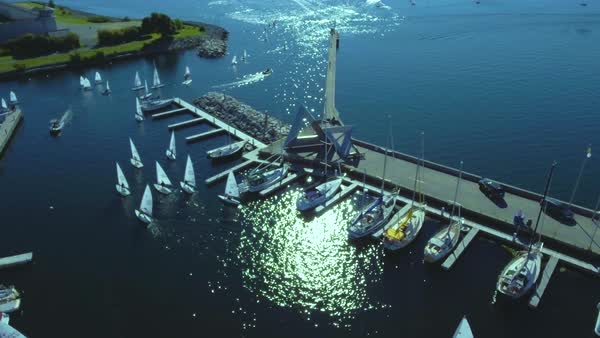 Rotating drone view of an port full of boats, ships entering in port ...