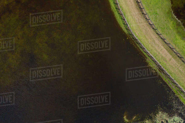 Aerial photograph of a horse trotting track near a fresh water lake in ...