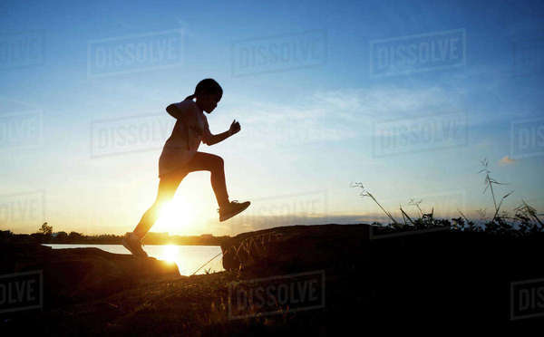 The silhouette of a girl jumping over a stone gap - Royalty-free Stock ...