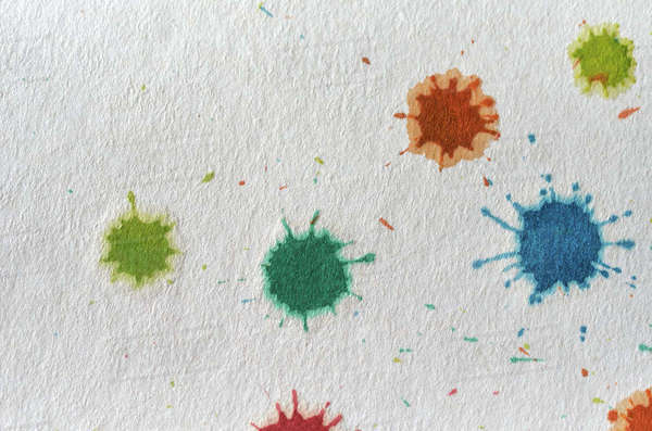 Colorful color stains on the rough textured paper - Stock Photo - Dissolve
