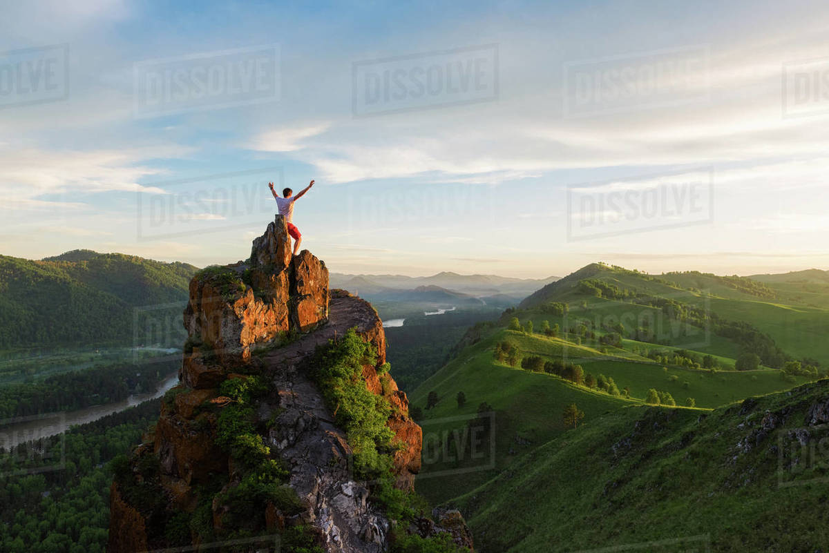 Travel, freedom leadership and real life concept - man standing on top ...