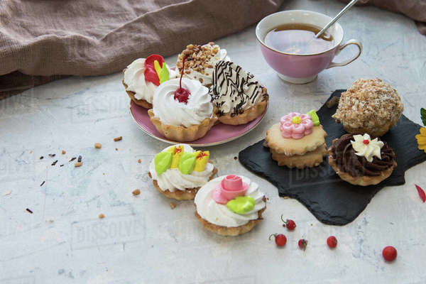 Different cakes composition on concrete background - Stock Photo - Dissolve