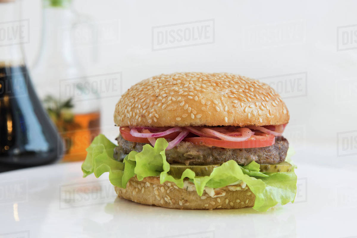 Tasty classical burger with meat cheese lettuce onion, tomato and sauce ...