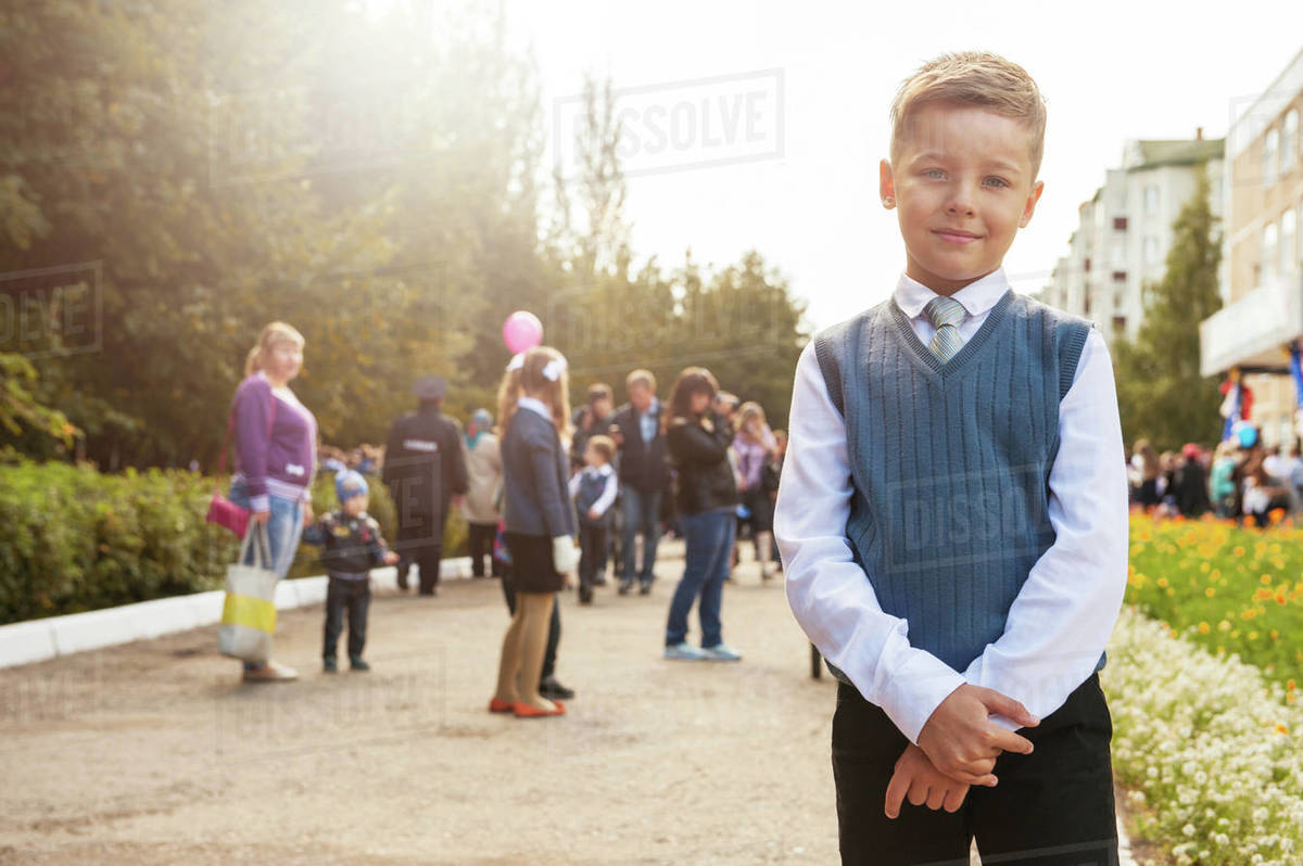 The first time in first class: happy schoolboy at school background ...