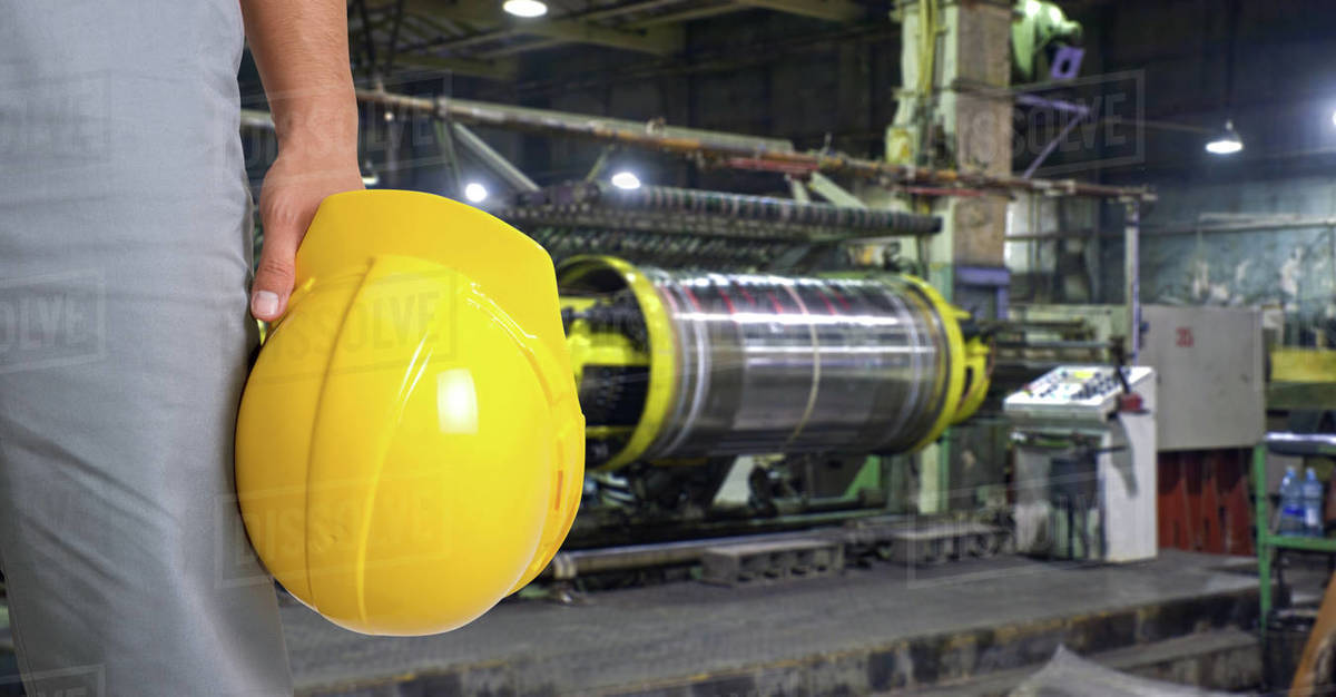 Worker with safety helmet at industrial factory - Stock Photo - Dissolve
