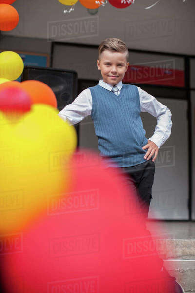 The first time in first class: happy schoolboy at school background ...