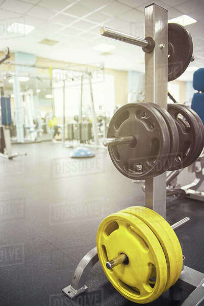 At the fitness modern gym with equipment. Disc weights on the ...