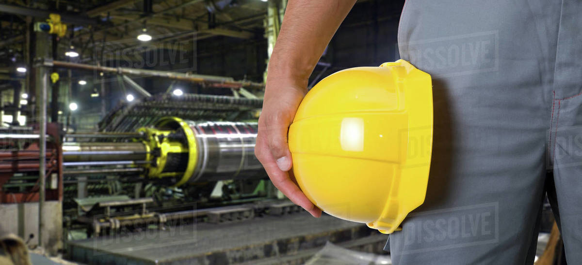 Worker with safety helmet at industrial factory - Stock Photo - Dissolve