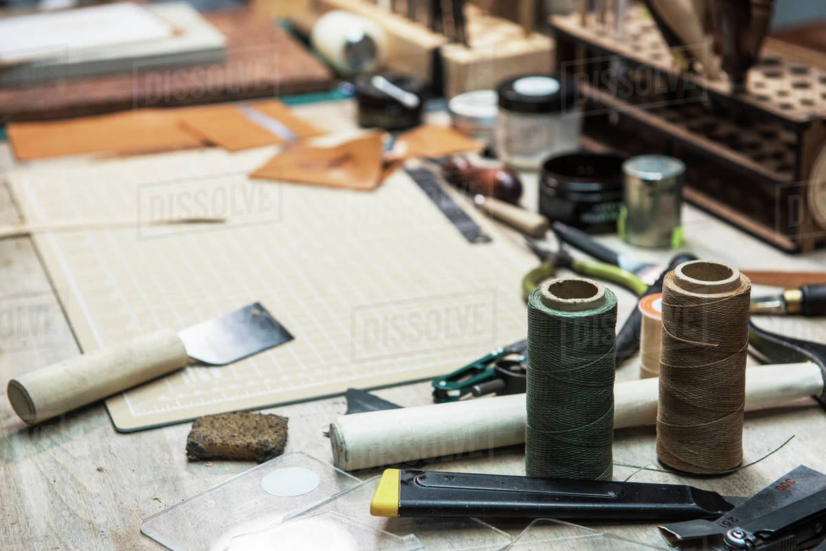 Leathermaker's work desk. Tools and leather at cobbler workplace. Tools ...