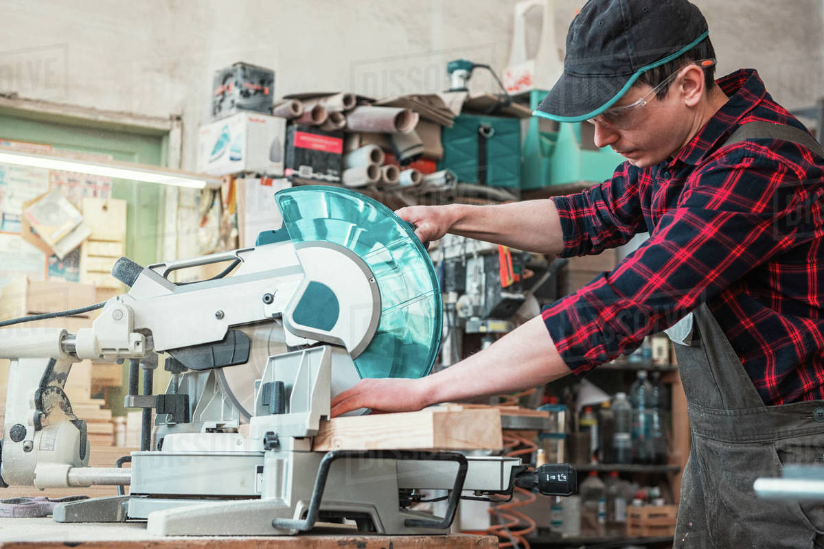 Carpenter cutting wooden board with circular saw. Profession, carpentry ...