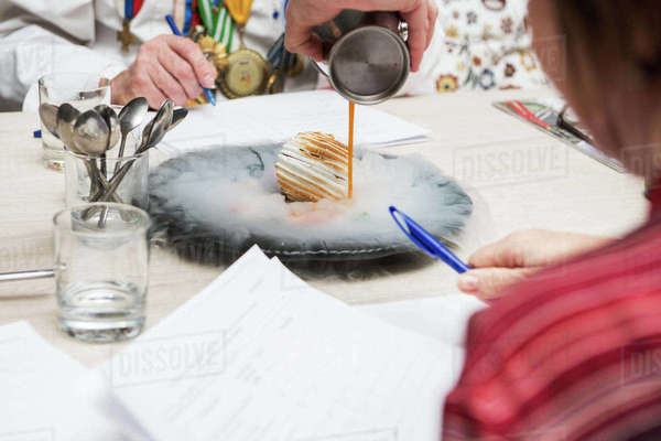 Tasting and evaluation of food by a certified specialist. A ...