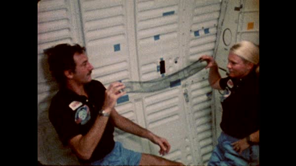 Astronaut Jeff Hoffman and Rhea Seddon play with a slinky on board ...