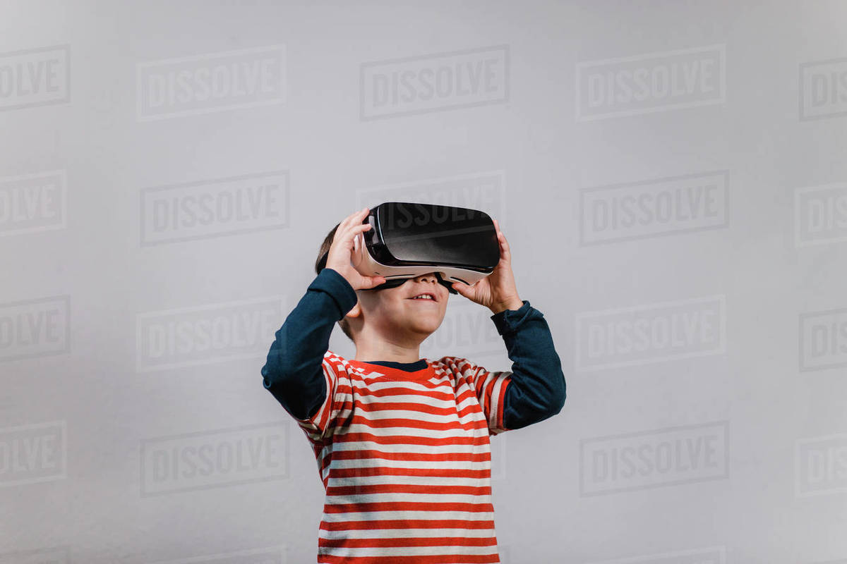 Excited kid having fun with VR glasses. Portrait of cheerful child ...