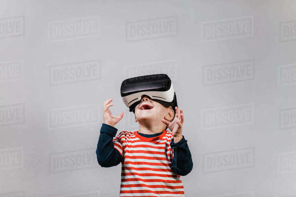 Excited kid having fun with VR glasses. Portrait of cheerful child ...