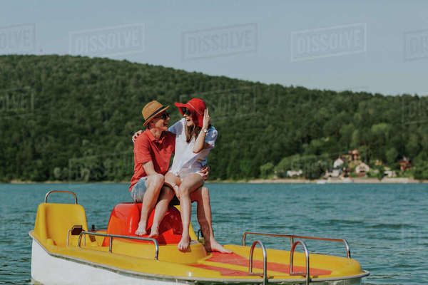 Couple in love laughing while boating in the lake. Portrait of young ...