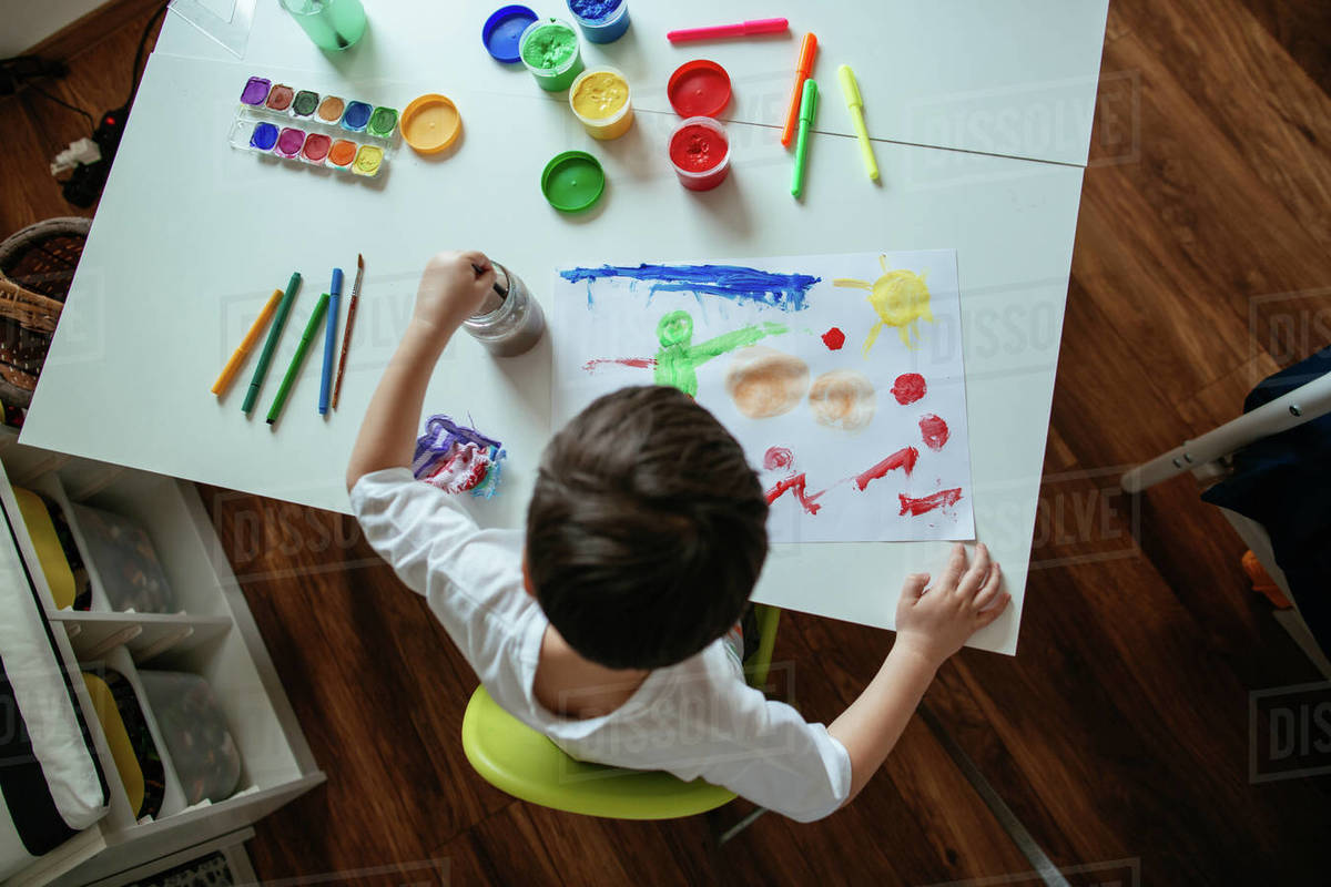 Top View of 5 Year Old Left Handed Boy Cleaning Paintbrush from Paint ...