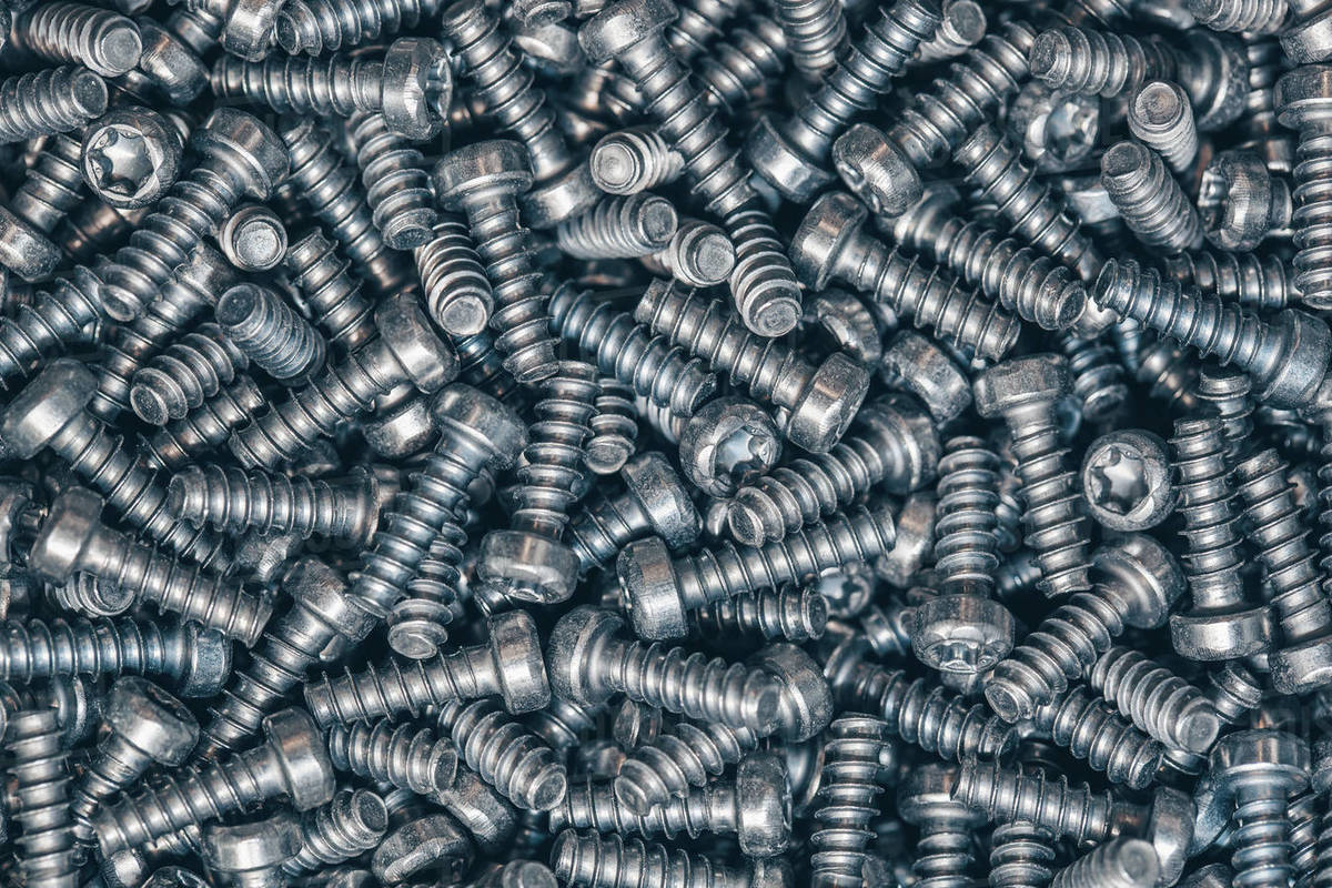 A lot of taping metal or iron screws, screws as a background, wallpaper ...