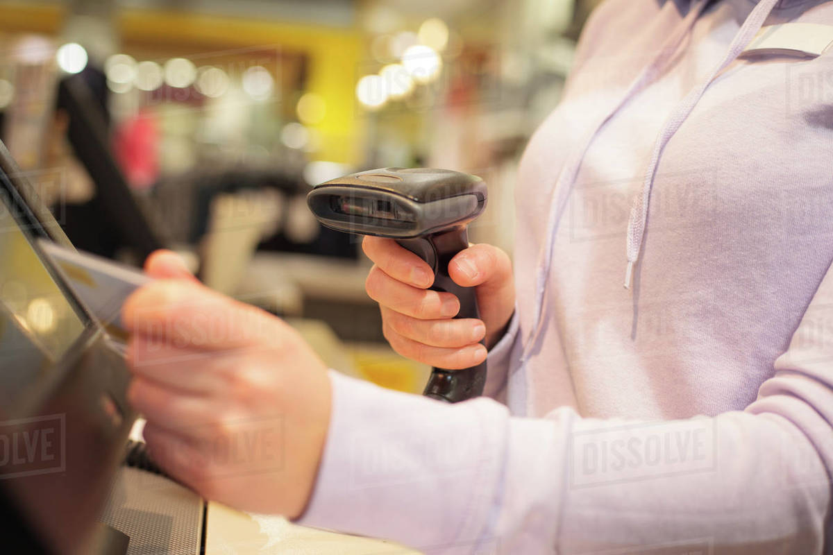 Young woman hands using scanner for scanning goods for a customer at ...