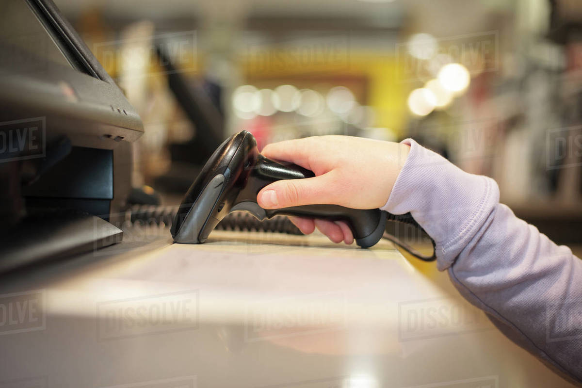 Young woman hands using scanner for scanning goods for a customer at ...