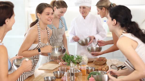 During meeting with friends at culinary courses, young female visitor ...