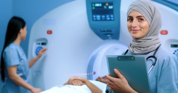 Arabian doctor with stethoscope holding folder. Muslim doctor in hijab ...