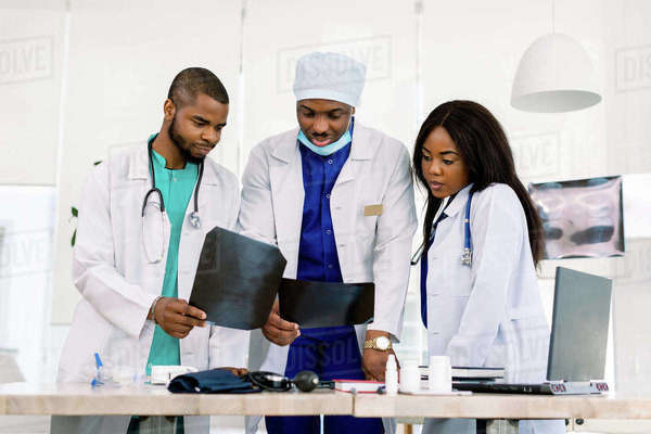 team of young African doctors discussing radiology images of patients ...