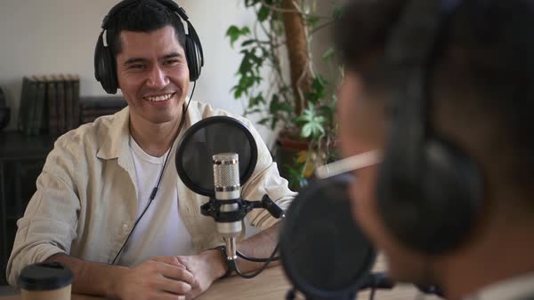 Radio host man laughing while streaming radio with coworker presenter ...
