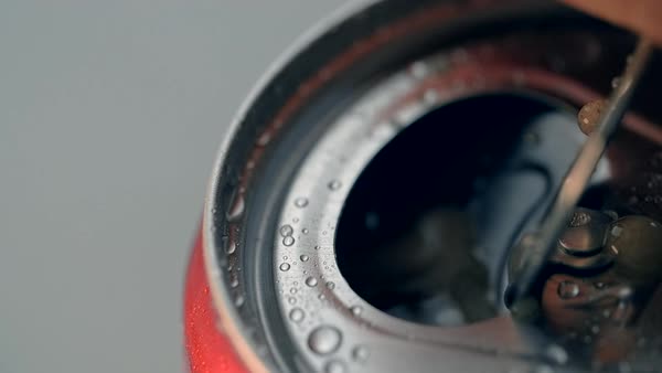 Cola can is opened in slow motion. Macro shot of the opening of the ...